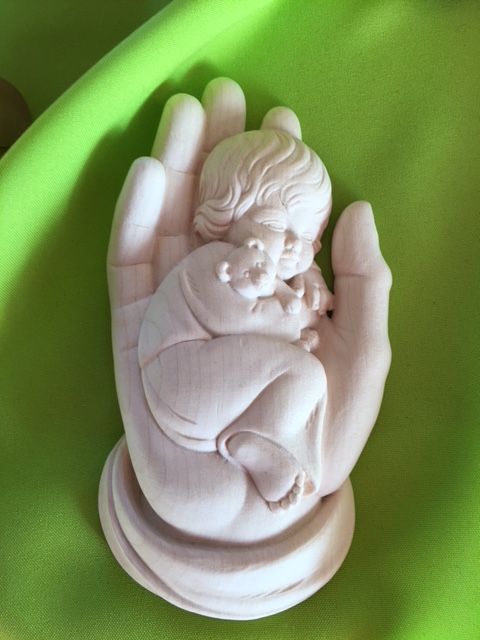 Kind in Gottes Hand, geschnitztes Relief aus Holz